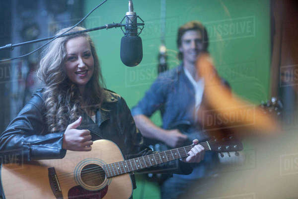 Two musicians in recording studio, playing guitar - Stock Photo - Dissolve