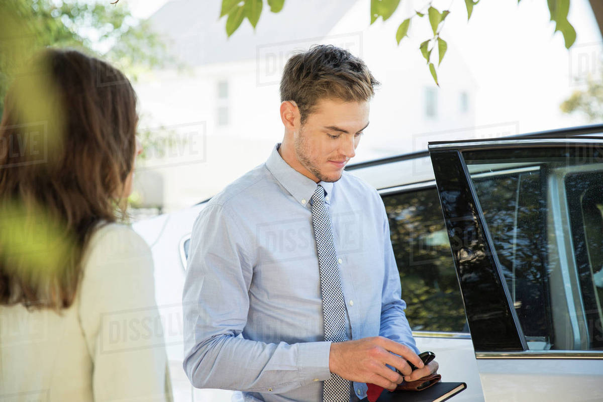 Young businessman on street preparing to leave in car - Royalty-free ...