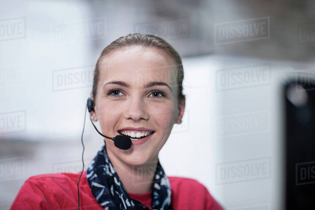 Portrait of female telephonist working in call centre - Royalty-free ...