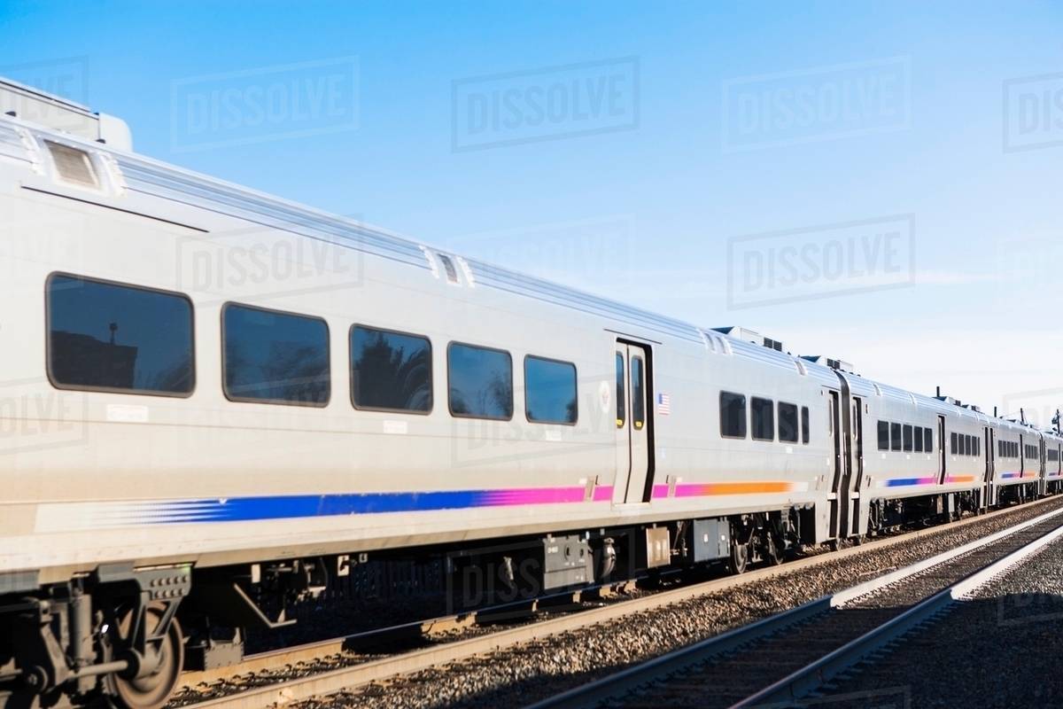 Passenger train on railroad - Stock Photo - Dissolve