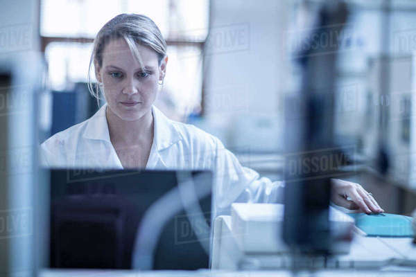 Woman in laboratory, using computer - Royalty-free Stock Photo | Dissolve