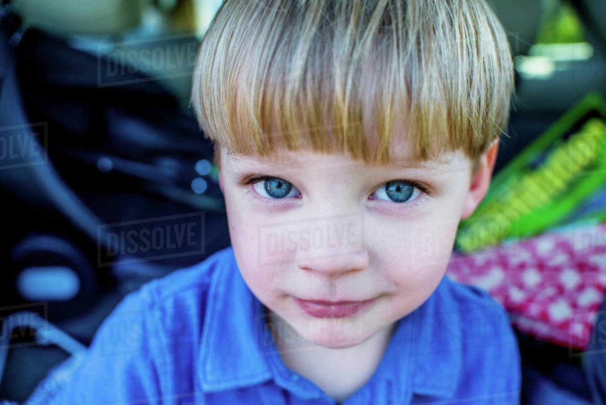 Portrait of boy looking at camera smiling - Stock Photo - Dissolve