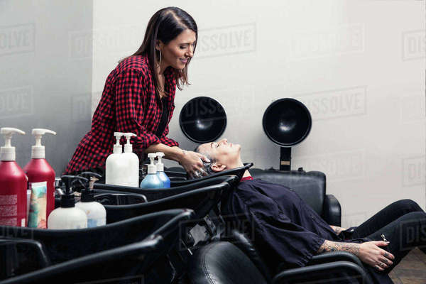Shampoo girl rinsing customer's hair in salon - Royalty-free Stock ...