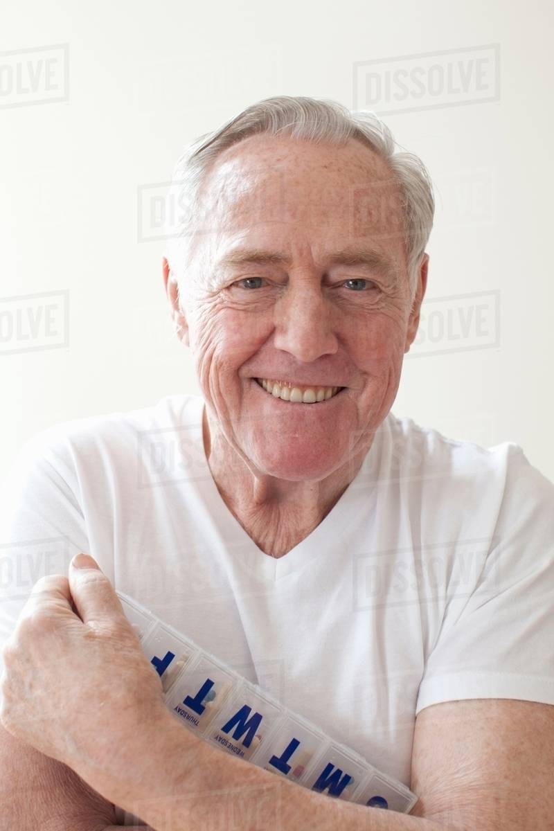 Senior man holding pill box - Royalty-free Stock Photo | Dissolve