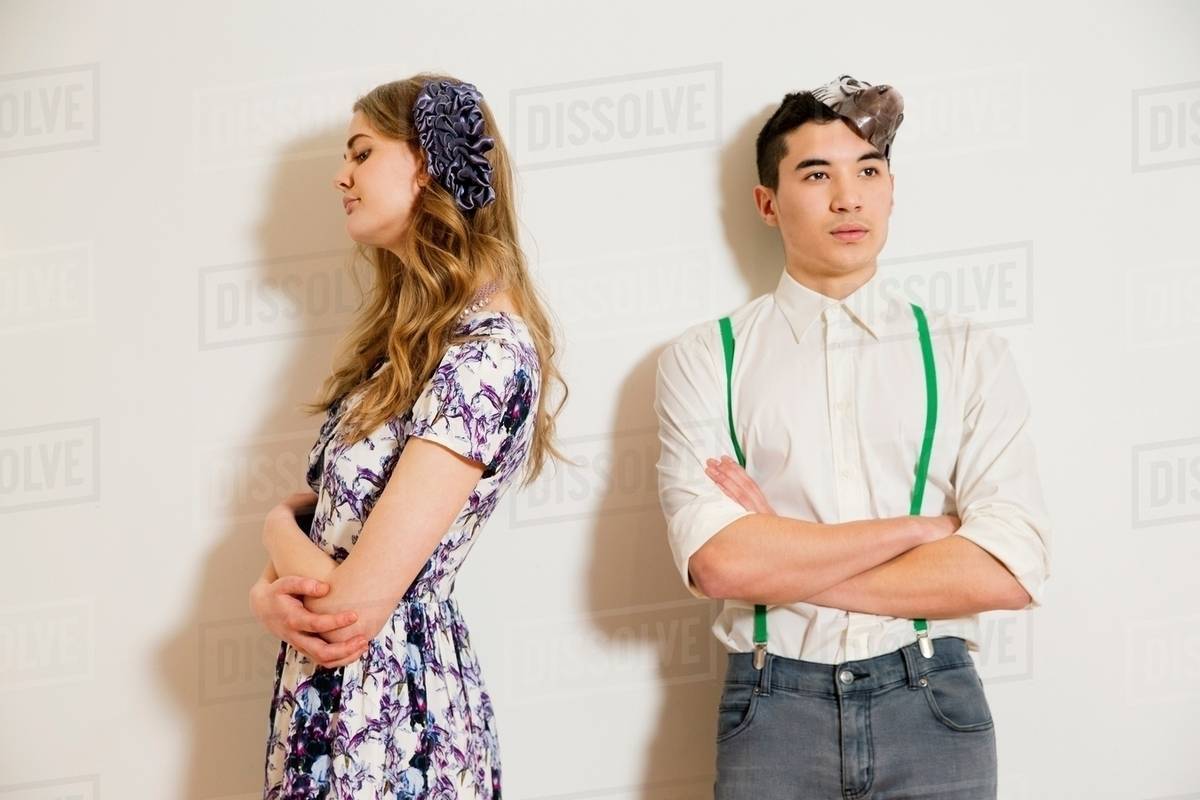 Portrait of young couple ignoring each other - Stock Photo - Dissolve