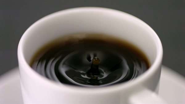 Drop of coffee falling into a cup of coffee - HD Rights-managed Stock ...