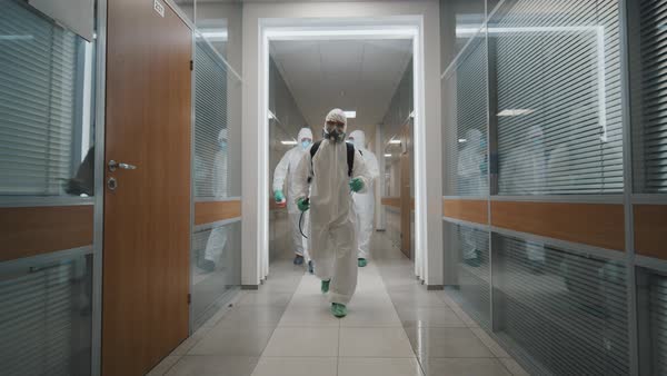 Specialists disinfecting empty office during quarantine of coronavirus ...