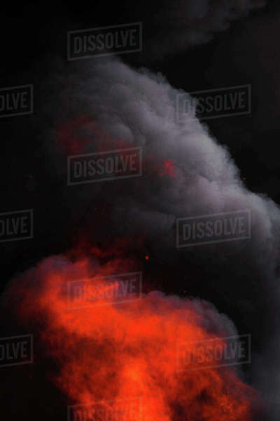 Dangerous red flames of strong fire and motion dramatic clouds of black ...