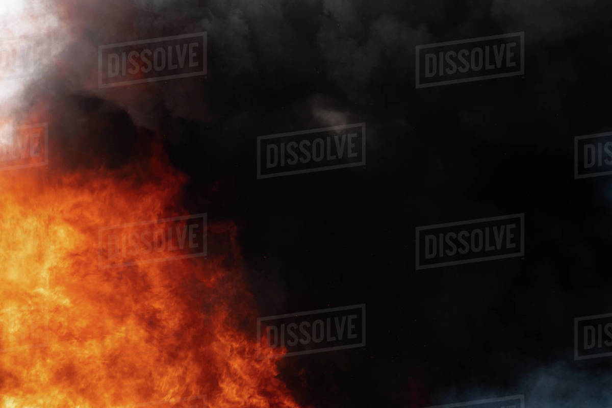 View of dangerous red flames of huge fire and motion clouds of black ...