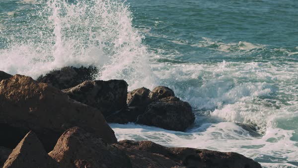 Ocean waves breaking over dangerous rocks in the Atlantic Ocean. Slow ...