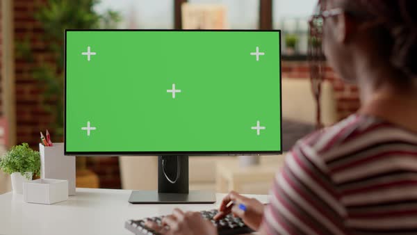 Freelancer woman working remotely with greenscreen on computer, using ...