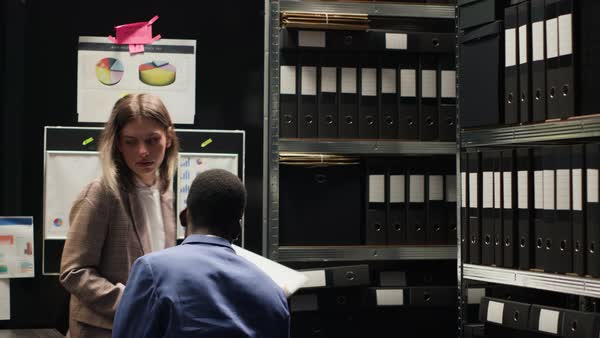 African american and caucasian police officers conduct detailed ...