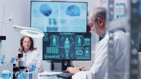 In modern high end laboratory two colleagues are talking about samples ...