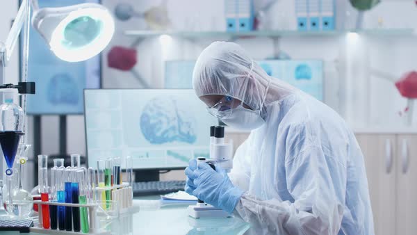 Scientist in advanced laboratory studying about brain disease. He looks ...