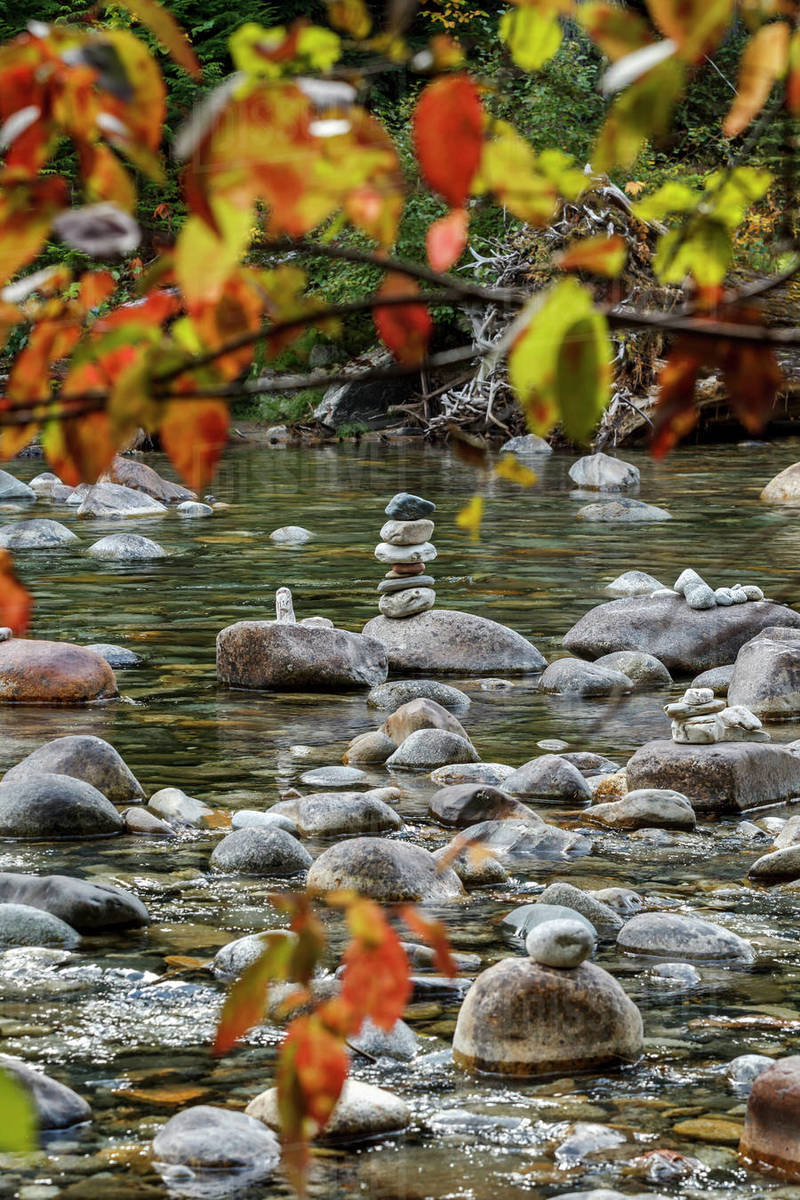 A rock cairn is visible through autumn leaves in Canada. - Stock Photo ...