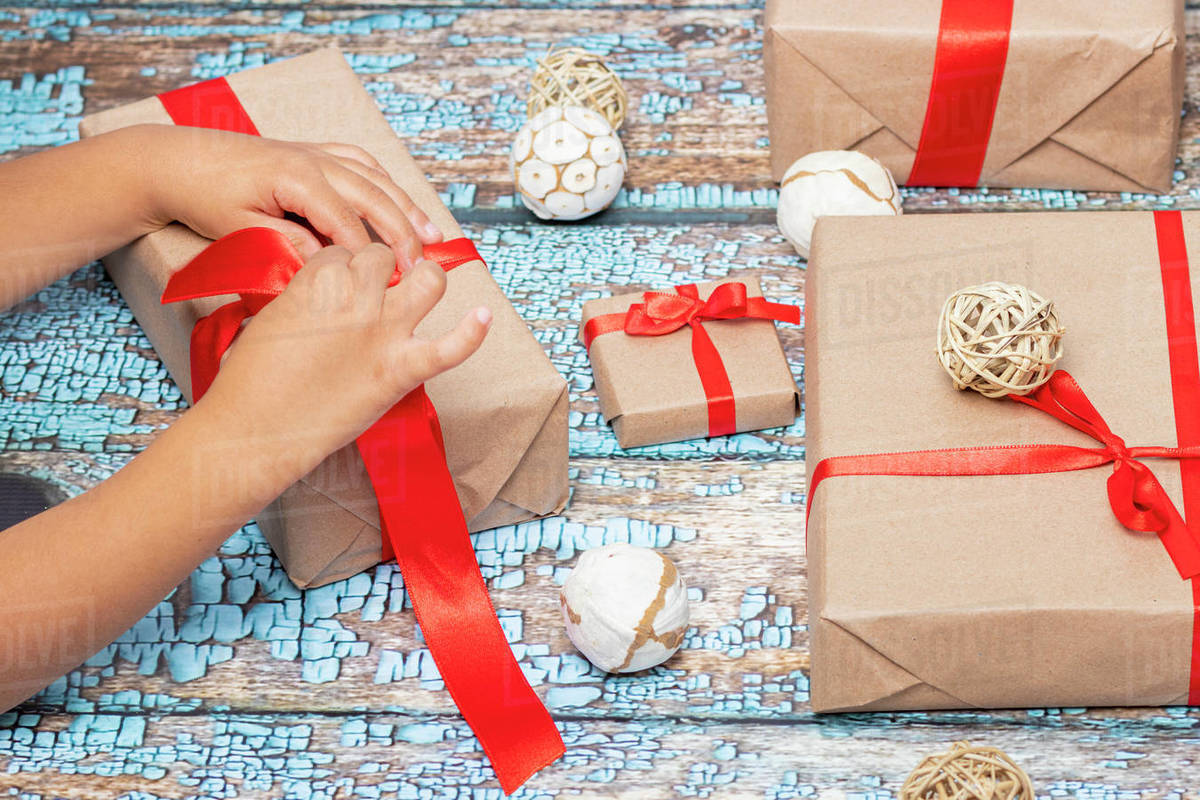 Little girl opening presents on Christmas day - Stock Photo - Dissolve