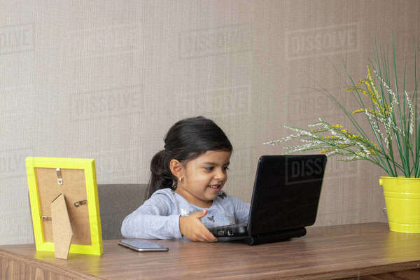 Cute little girl working in the office - Stock Photo - Dissolve