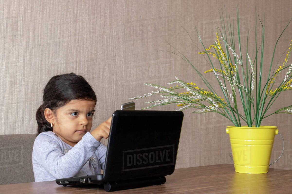 Cute little girl working in the office - Stock Photo - Dissolve