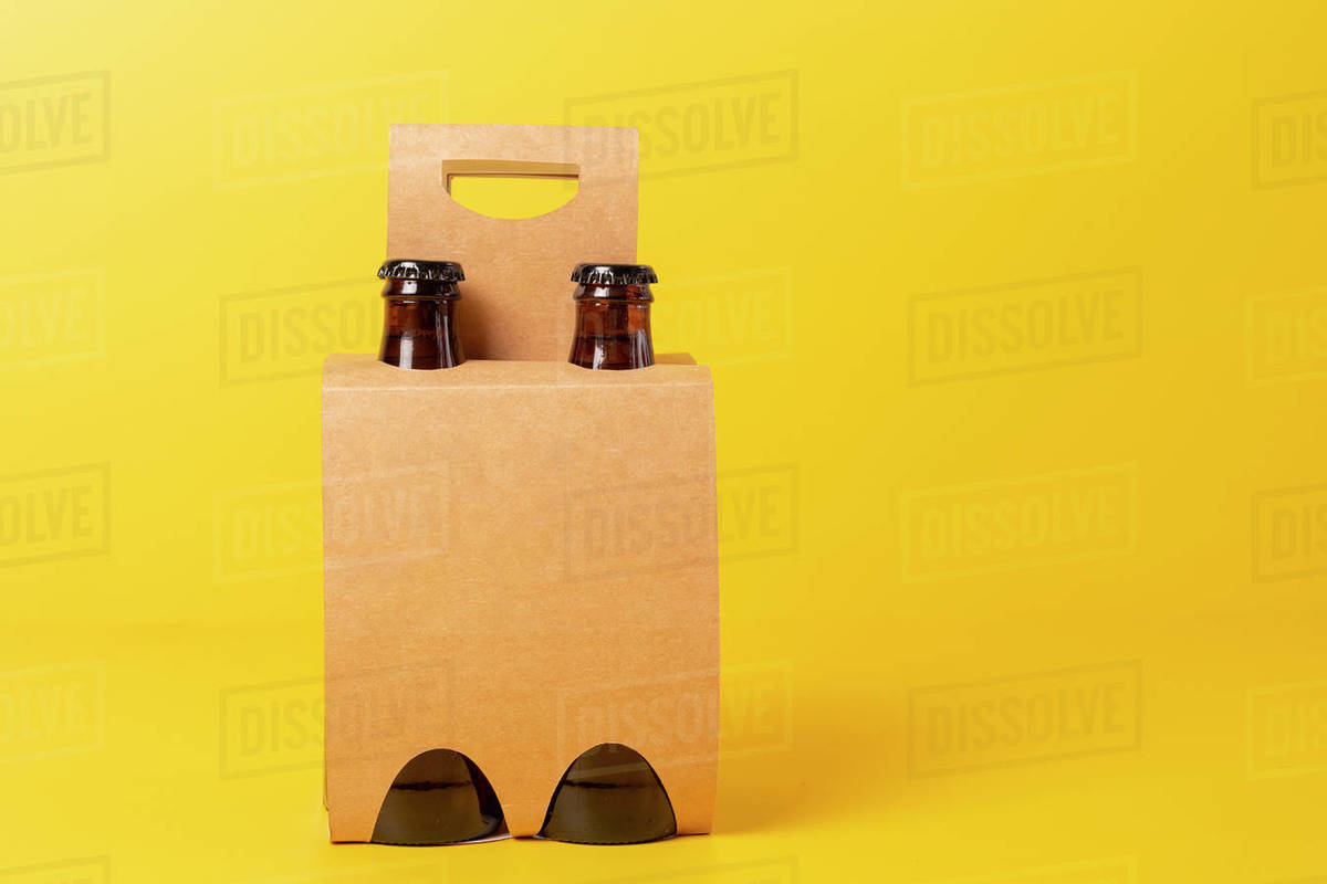 Presentation of pack of four beers with yellow background - Royalty ...