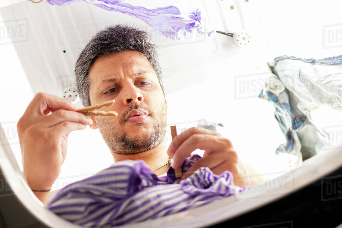 Bearded man using washing machine at home - Royalty-free Stock Photo ...