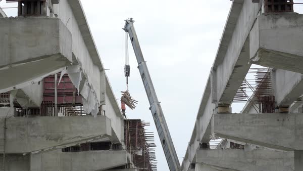 Construction work of a bridge at progress, Indian labor at work. Apple ...