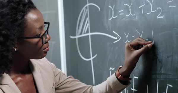 Close up of African American young woman teacher at school writing ...