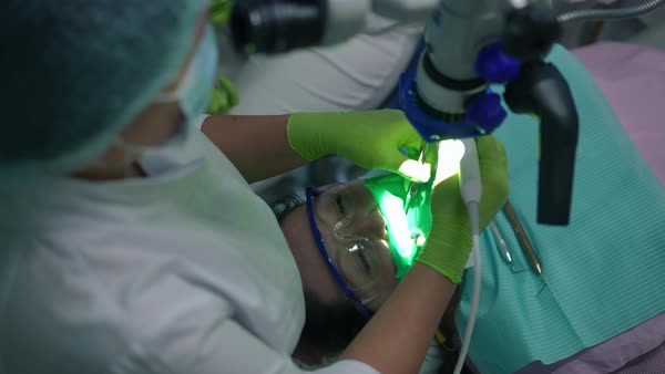 Top view patient in dental chair with professional orthodontist using ...