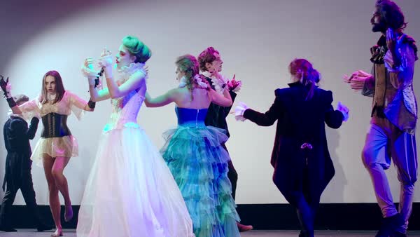 Wide shot actors and actresses in vintage costumes walking slowly on ...