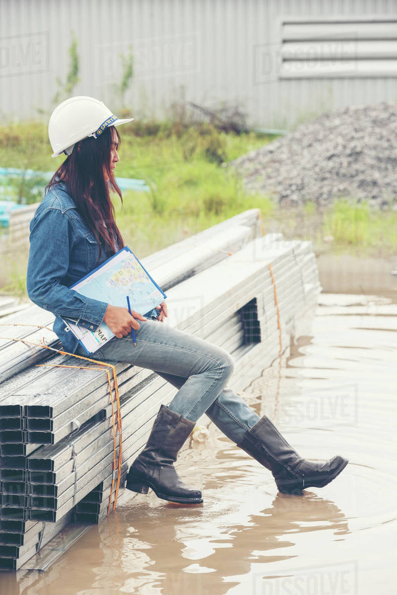 Woman construction engineer wear safety white hard hat at construction ...