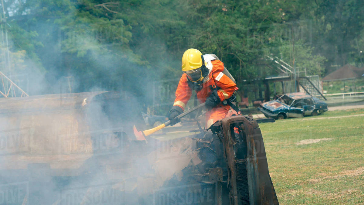 Firefighter fighting with flame using fire hose chemical water foam ...