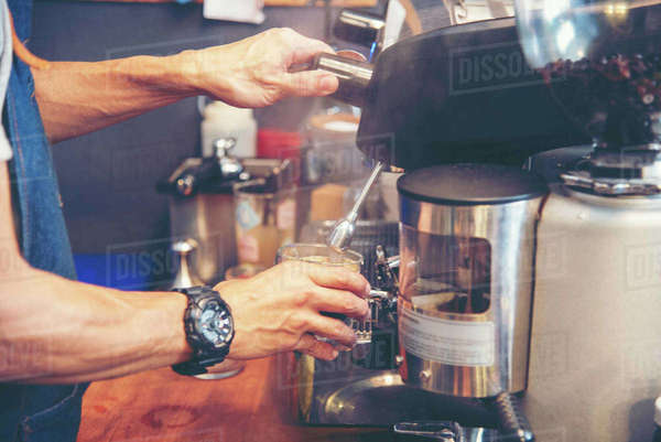 Coffee barista make espresso shot from coffee maker hot cup. Cappuccino ...