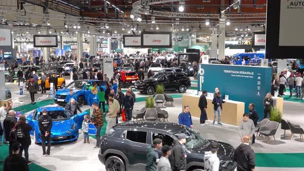 Helsinki, Finland - March 15, 2025: A crowded auto show with people ...