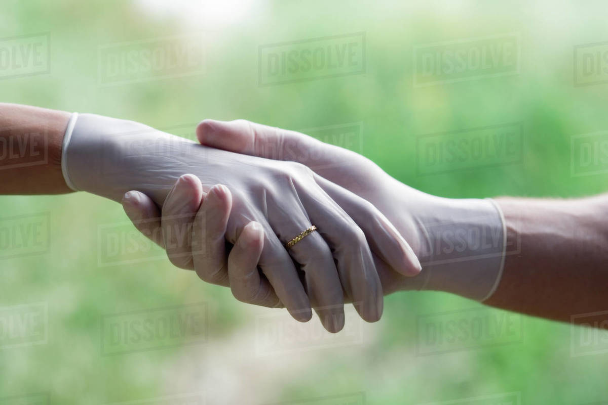 Romantic handshake wearing white rubber, gloves and ring - Royalty-free ...