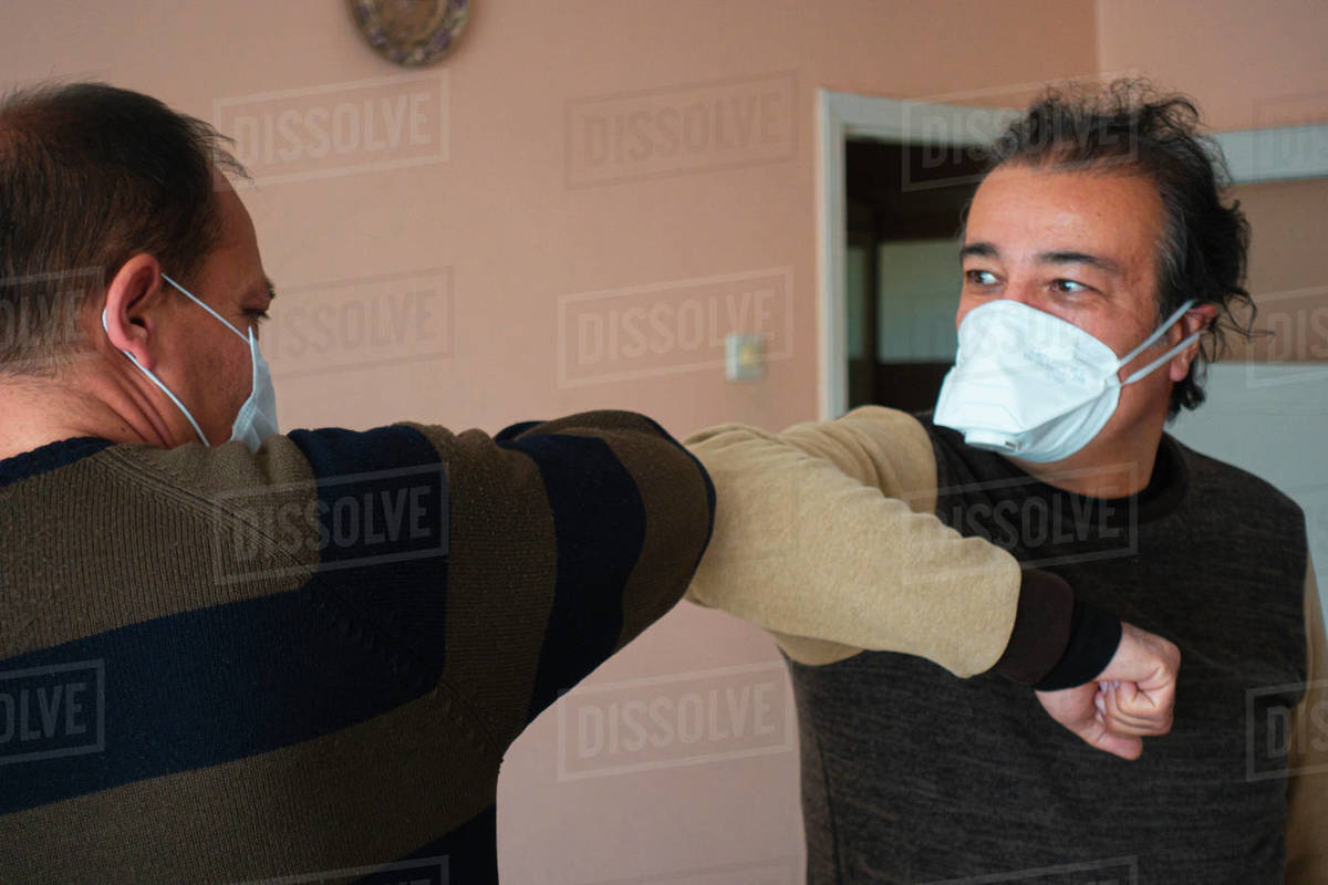 Two Turkish senior men with masks elbow bumping because of coronavirus ...
