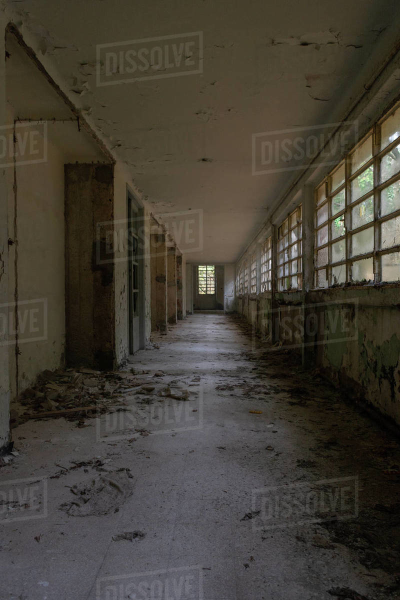 Old abandoned building house hallway with windows and broken glass and ...
