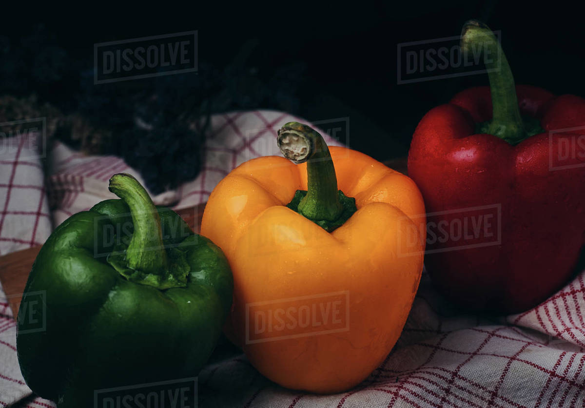 Colorful bell peppers on a table - Stock Photo - Dissolve