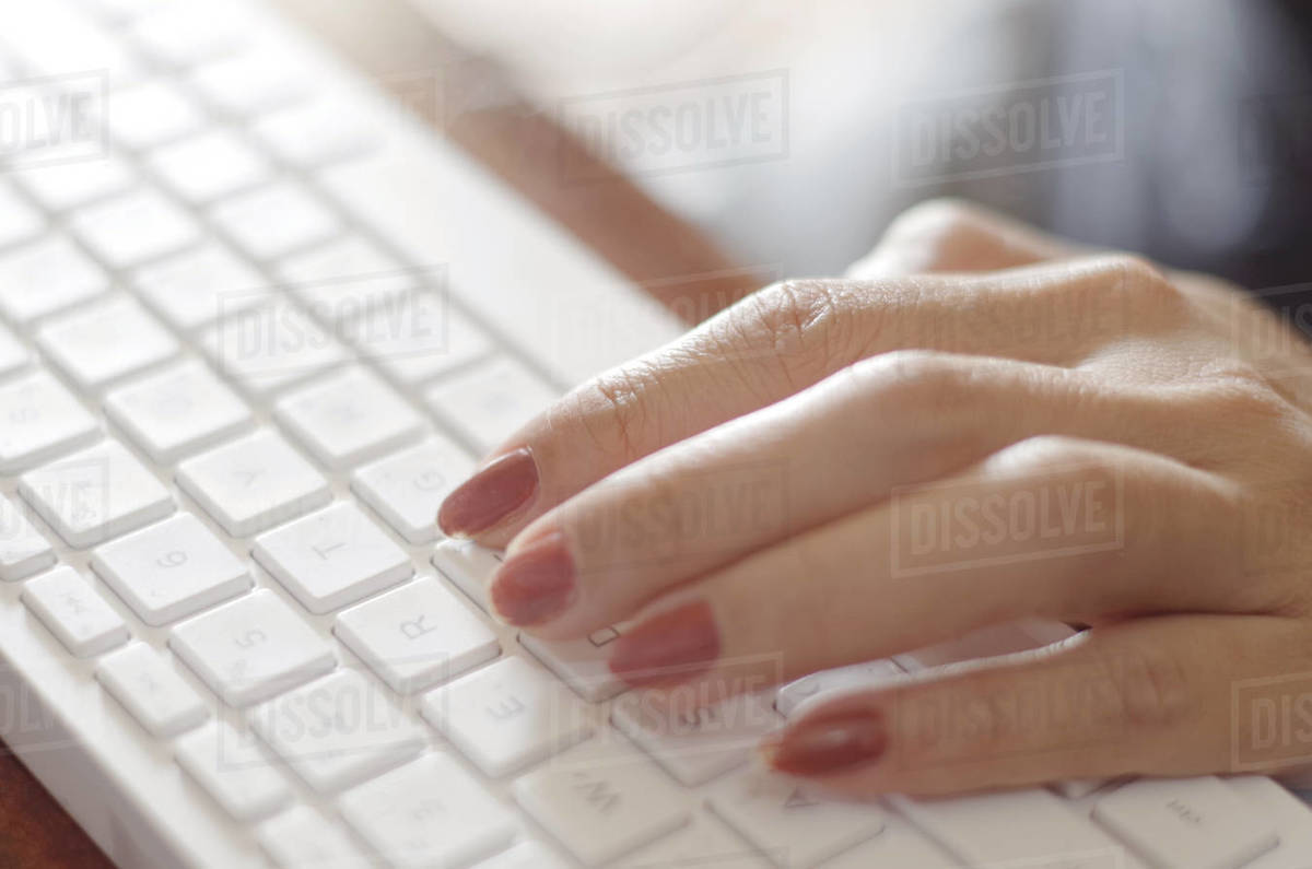 Woman hands typing on keyboard - Royalty-free Stock Photo | Dissolve