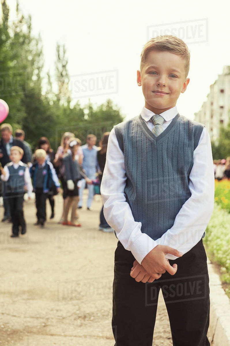 The first time in first class: happy schoolboy at school background ...