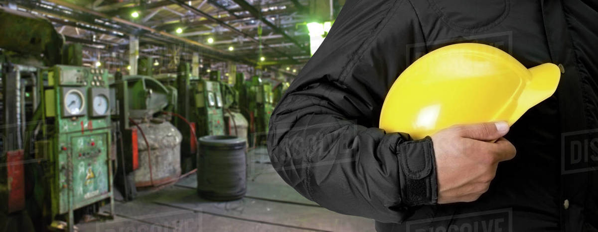 Worker with safety helmet at industrial factory - Stock Photo - Dissolve