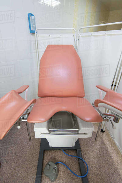 Gynecological cabinet with chair and other medical equipment in modern ...