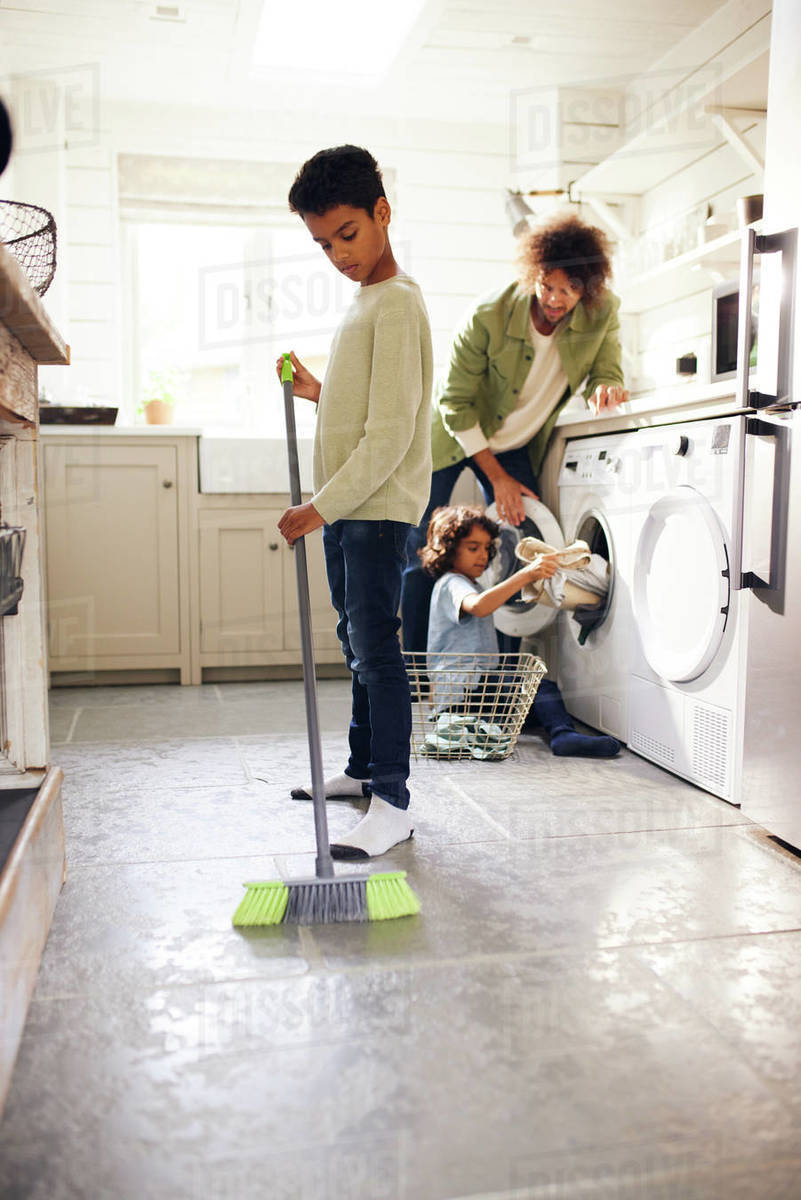 Two boys helping father with household chores - Stock Photo - Dissolve