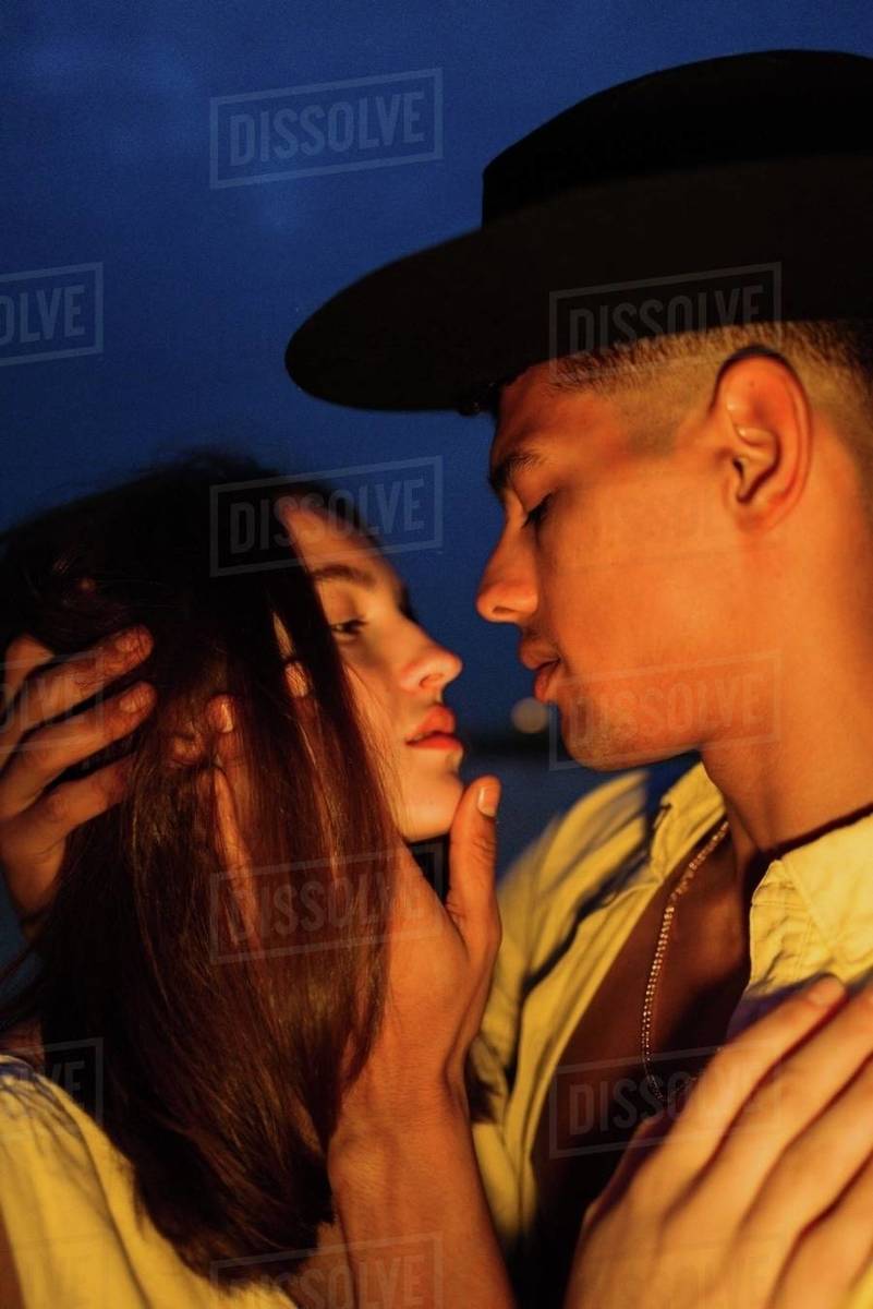 Couple hugging in the dark with neon light - Stock Photo - Dissolve
