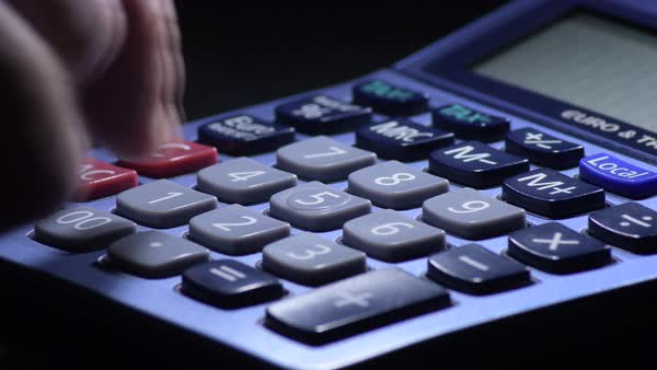 Calculating Costs with a domestic calculator - 4K Royalty-free Stock ...
