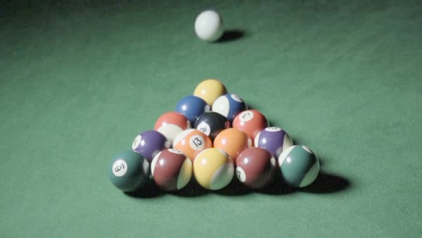 Pool ball collision. Close-up high-speed view of a cue ball (white ...