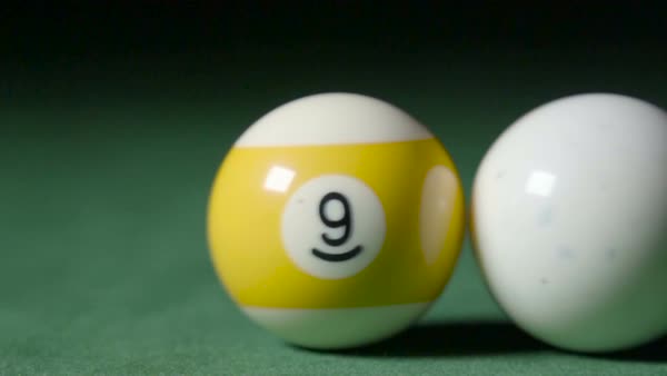 Pool ball collision. Close-up high-speed view of a cue ball (white ...