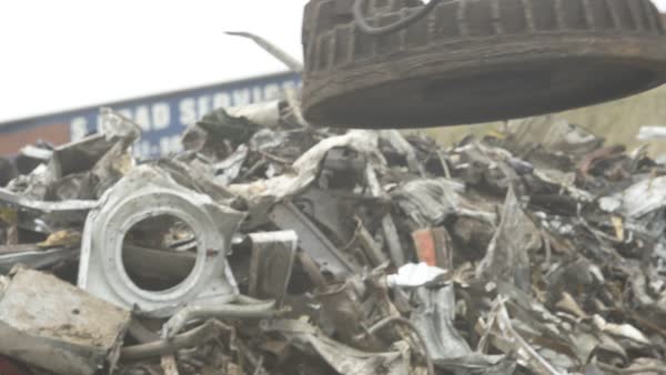 Electromagnet picking up and releasing metal objects at a scrap metal ...