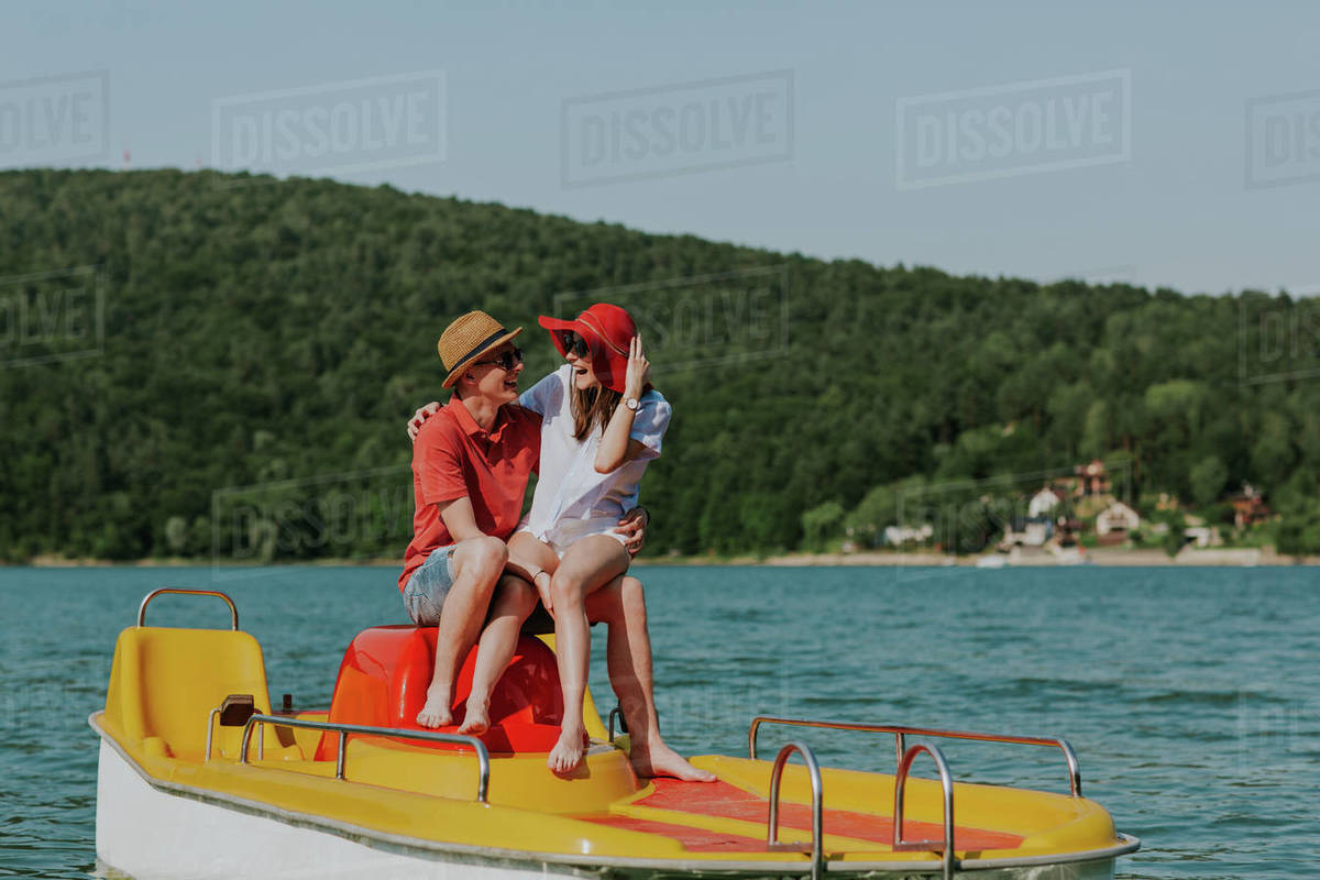 Couple in love laughing while boating in the lake. Portrait of young ...