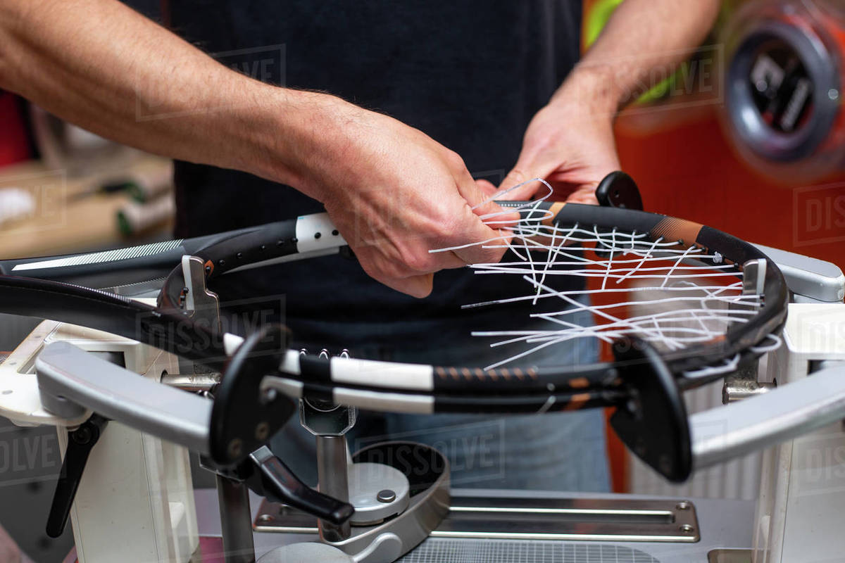 Process of stringing tennis racket in a tennis shop, sport and leisure ...