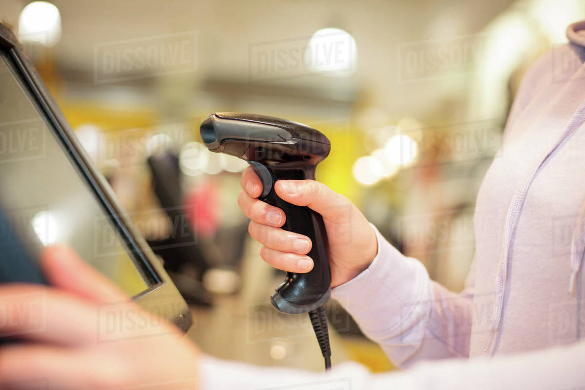 Young woman hands using scanner for scanning goods for a customer at ...
