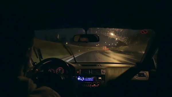 Male driving personal car on highway at night and rainy conditions ...